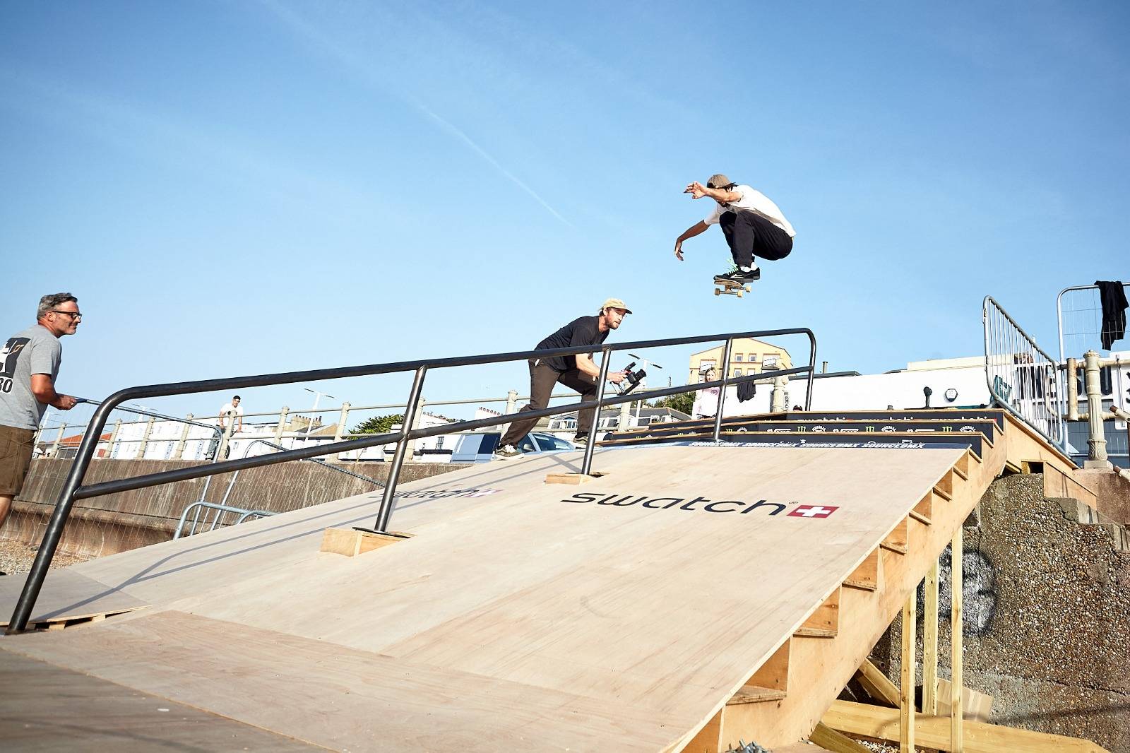 Chris skates the Swatch Beach Rail | Source Skate Co